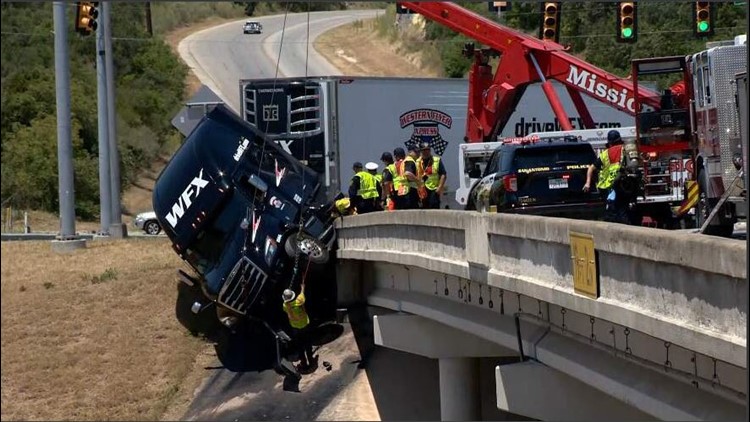 Big rig hanging over bridge causes lane closures on Loop 1604 | khou.com
