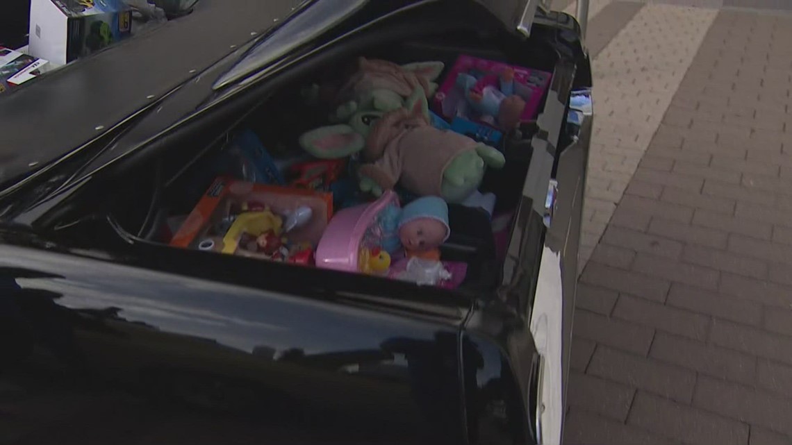 Classic cars drop off donations for Secret Santa Toy Drive | khou.com