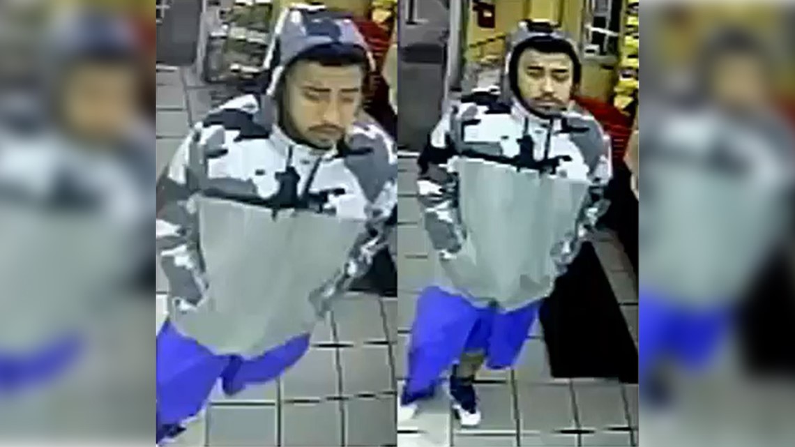 Watch: Suspect talks on cell phone during meat market robbery | khou.com