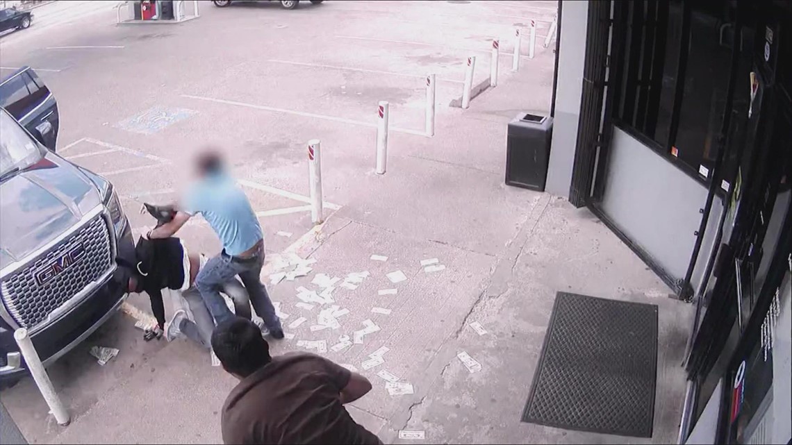 Cash flies as robbers attack owners in front of store | khou.com