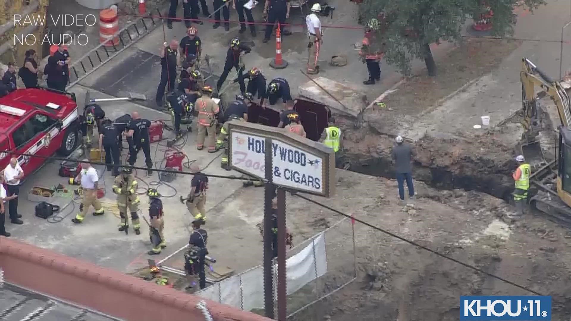 Raw video: Crews work to rescue two people who fell into hole at ... Raw video: Crews work to rescue two people who fell into hole at ...