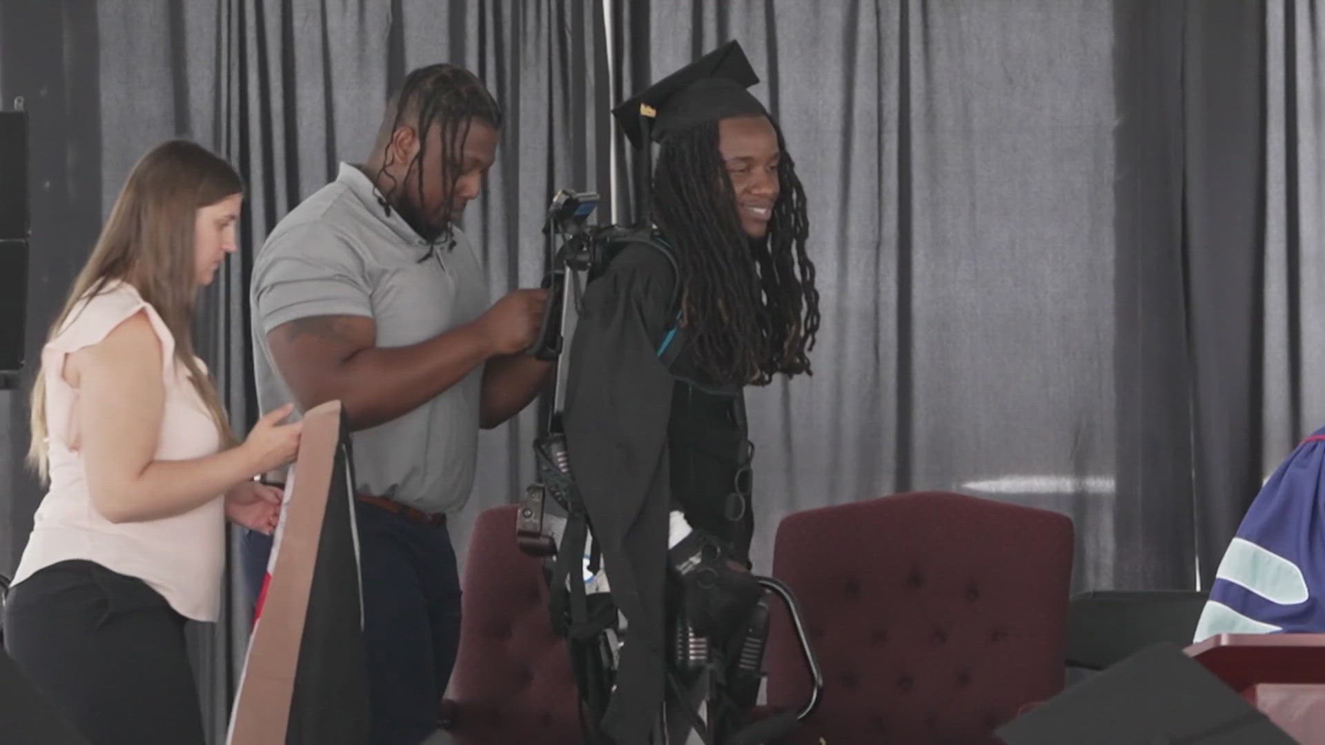 Paralyzed graduate walks stage with help of robotic exoskeleton | khou.com