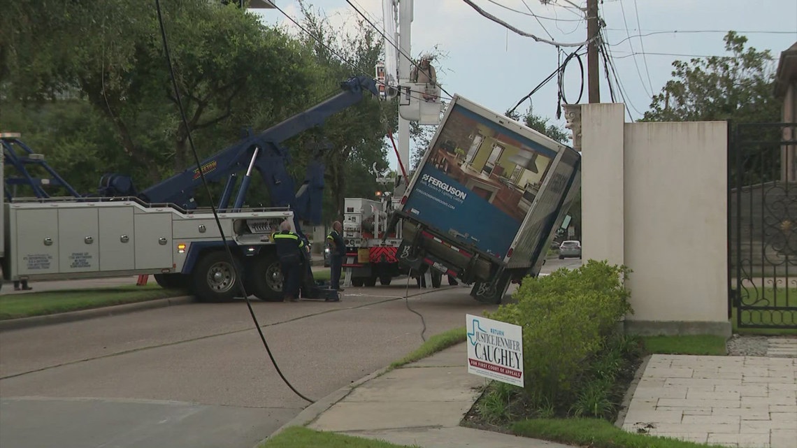 Truck gets caught in utility wires in west Houston | khou.com
