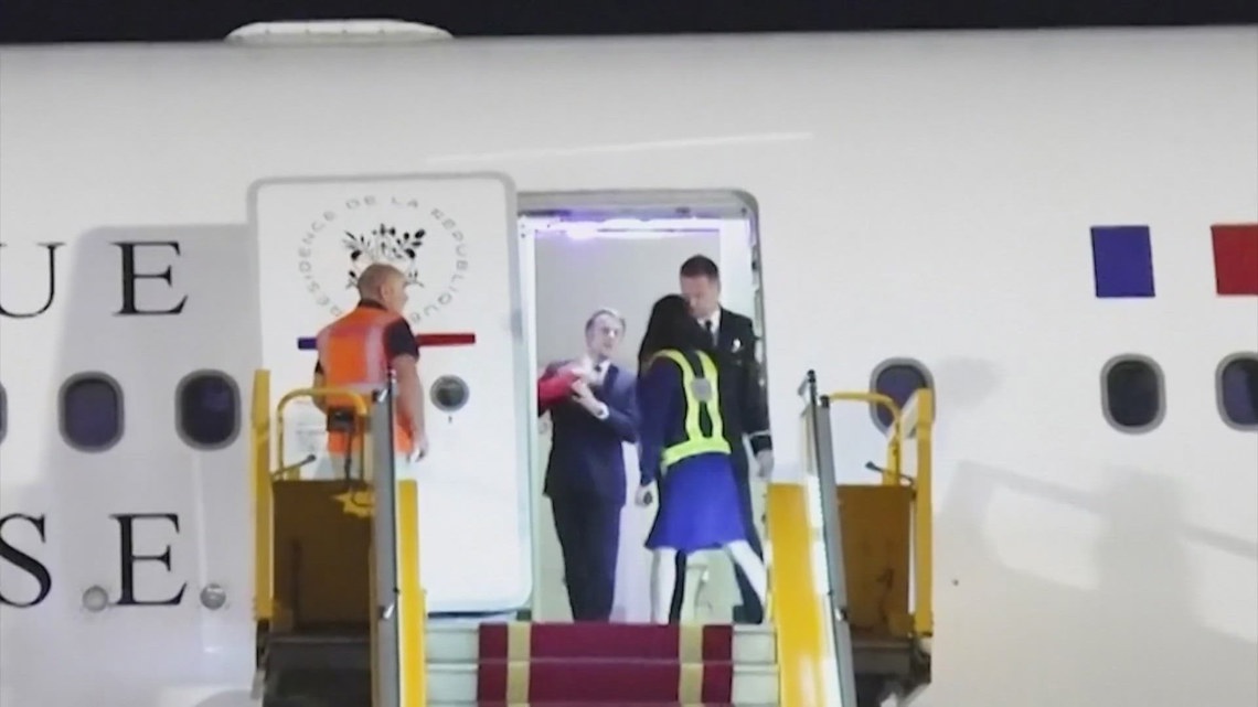 France's first lady seems to push her husband as they land in Vietnam ...