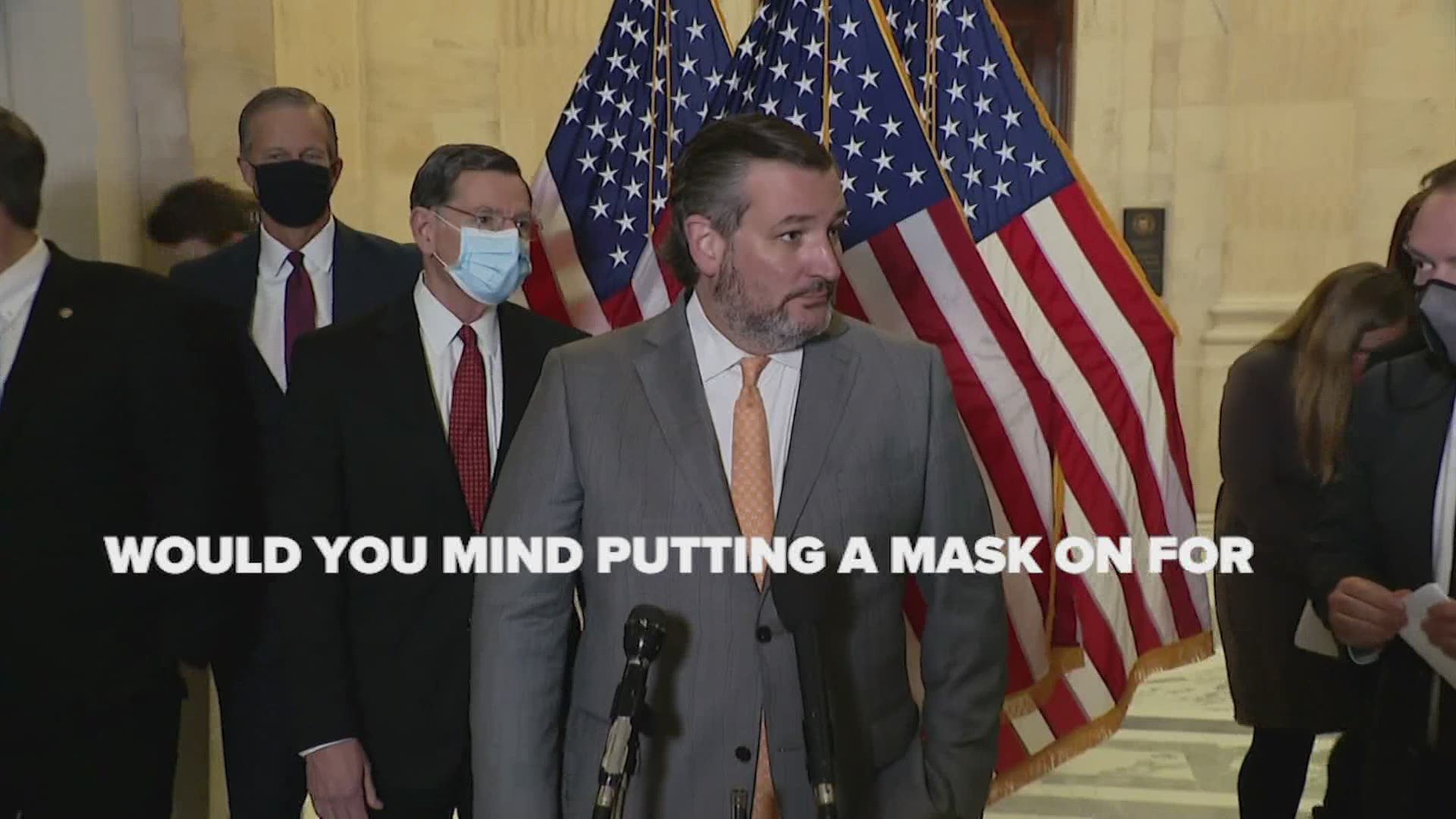 Sen. Ted Cruz responds to a reporter who asked him about not wearing a ...