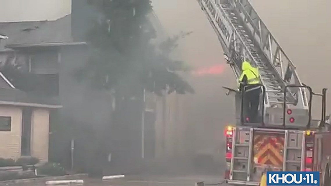 Houston firefighters work to control apartment fire as strong storms ...