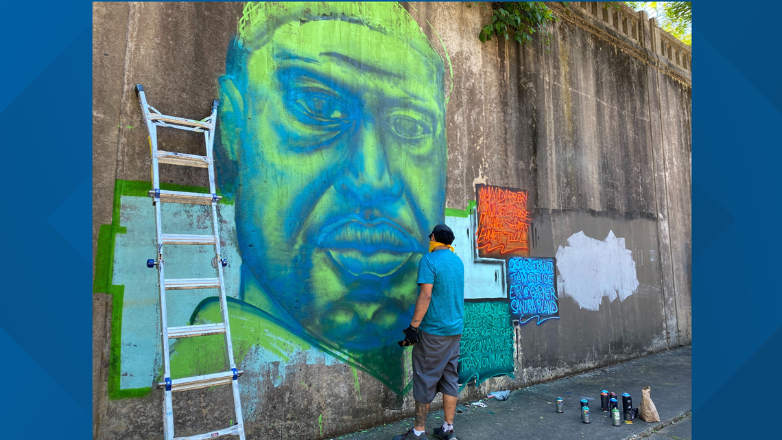 Artists add George Floyd portrait to mural in Little Rock | khou.com